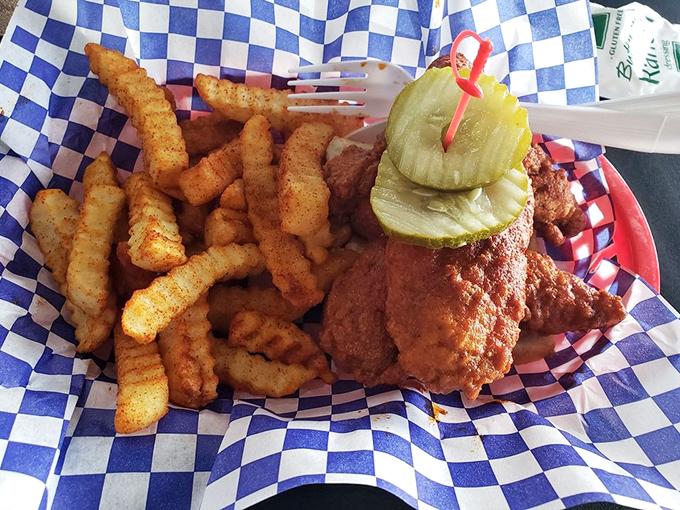 Classic hot chicken and seasoned fries &ndash; a pairing as perfect as Johnny and June. Those pickle chips aren't just garnish; they're essential flavor companions.