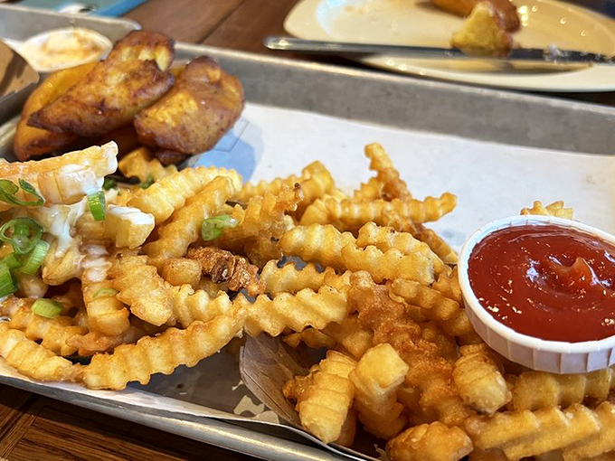 Crinkle-cut fries and sweet plantains sharing a tray&mdash;proof that different backgrounds can make for the most delicious friendships.