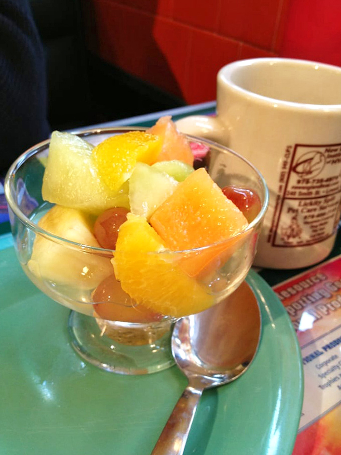 Fresh fruit that actually tastes like fruit! A simple pleasure alongside that signature Owl Diner coffee mug &ndash; breakfast balance at its finest.