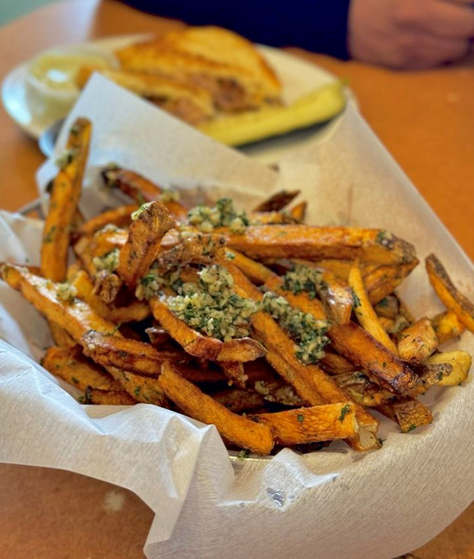 These garlic fries aren't just a side dish – they're the supporting actor who steals the entire show.