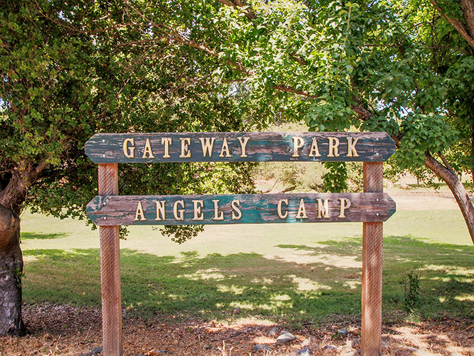 Gateway Park's rustic sign welcomes visitors to a shady retreat, perfect for picnics and contemplating the town's colorful history.