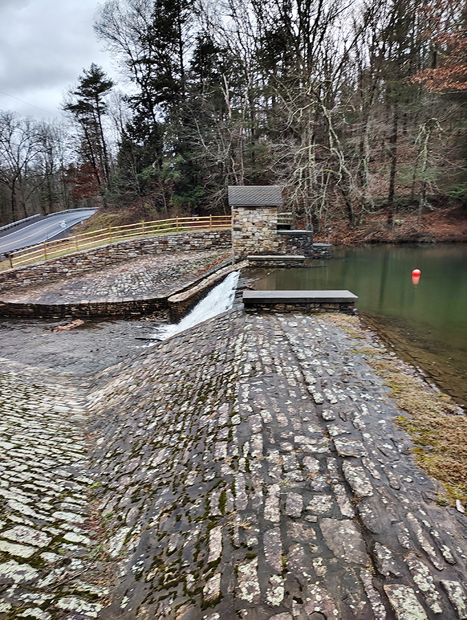 Stone craftsmanship that's stood the test of time. Water tumbles over this historic dam, a reminder of human ingenuity amid nature's splendor.