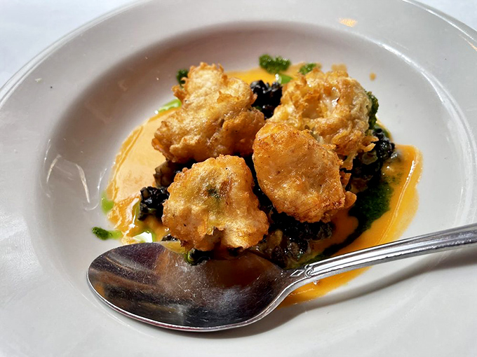 Golden-fried morsels that crunch like autumn leaves, swimming in a sauce worth bottling. I'd drink it straight if society allowed.