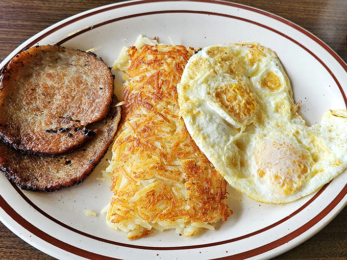 Breakfast doesn't get more straightforward than this&mdash;eggs, hash browns, and ham steak forming the holy trinity of morning satisfaction.