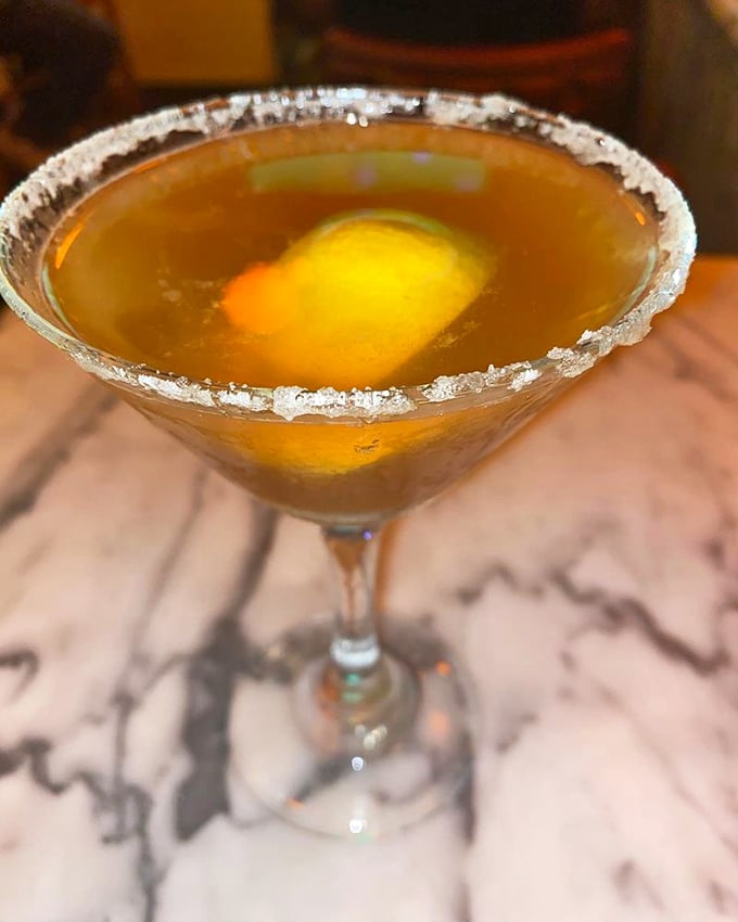 A Hennessy Side Car with a sugar-rimmed glass that catches the light like diamonds. This isn't just a cocktail; it's liquid amber jewelry.