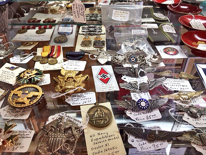 Military insignia and medals that once adorned brave chests now rest behind glass, silent testimonies to service and sacrifice across generations of American history.