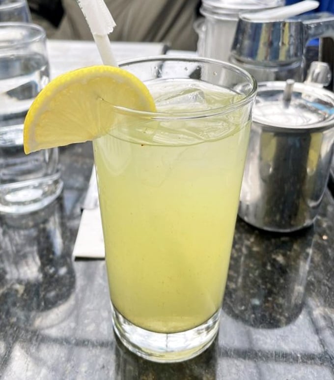 That's not just lemonade&mdash;it's liquid sunshine with a ginger kick, served with a lemon slice that's basically wearing a "squeeze me" sign.