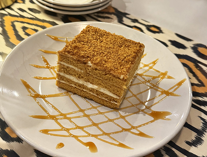 The honey cake stands tall and proud, layer upon delicate layer. Like the world's most delicious archaeology project, each forkful reveals new treasures.