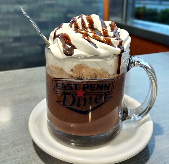 Hot chocolate elevated to an art form &ndash; topped with a cloud of whipped cream and chocolate drizzle in a mug that means business.