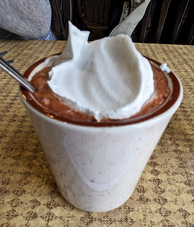 Hot chocolate crowned with whipped cream &ndash; winter's perfect antidote served in a no-nonsense mug.