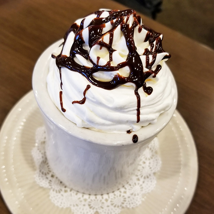 This isn't just hot chocolate&mdash;it's a mountain of whipped cream with chocolate drizzle that happens to have hot chocolate underneath. Dessert disguised as a beverage!