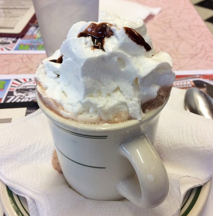 Hot chocolate crowned with a cloud of whipped cream. Winter comfort in a mug that makes you feel like you're eight years old again.