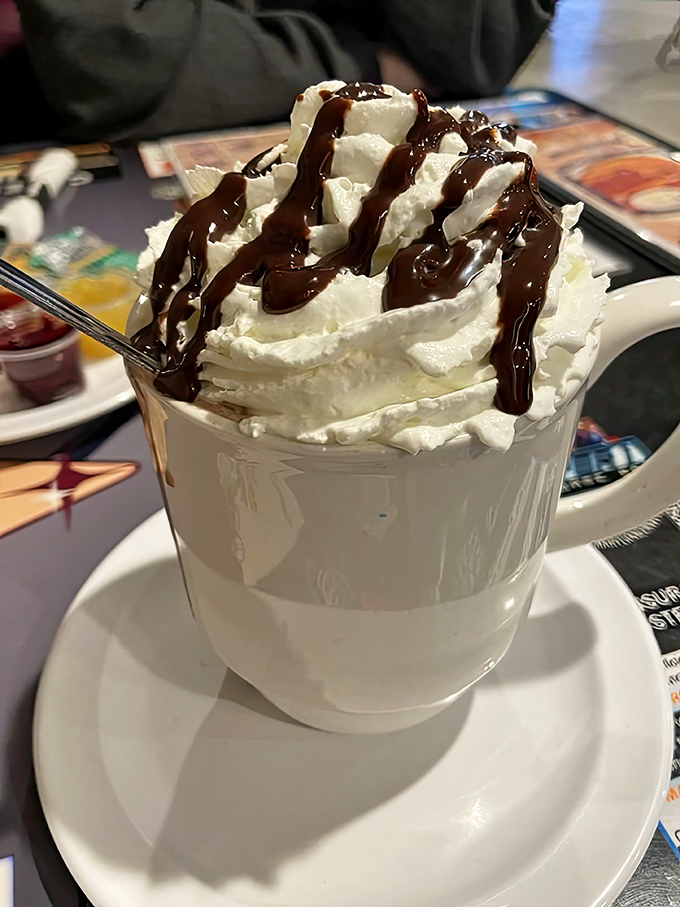 Hot chocolate topped with enough whipped cream to make your inner child do a happy dance at the table.