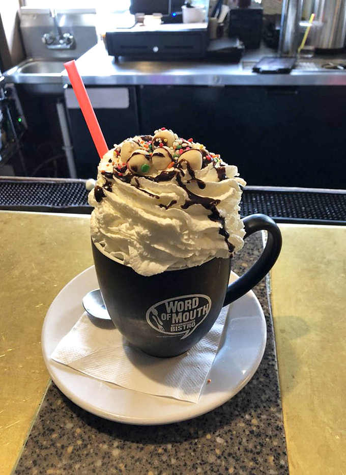 Hot chocolate elevated to an art form—whipped cream mountain, chocolate drizzle, and sprinkles that remind you it's never too early for joy.