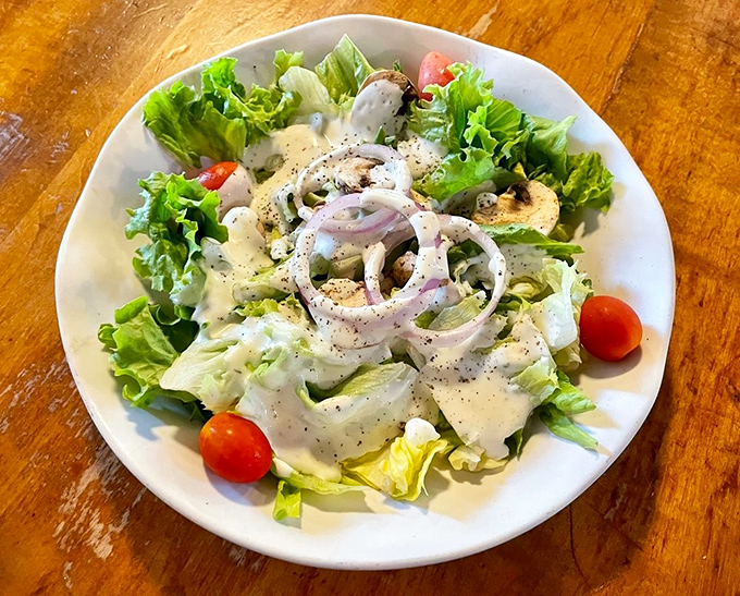A ranch salad that doesn't apologize for being a salad. Fresh, crisp, and adorned with enough red onions to keep vampires at bay.