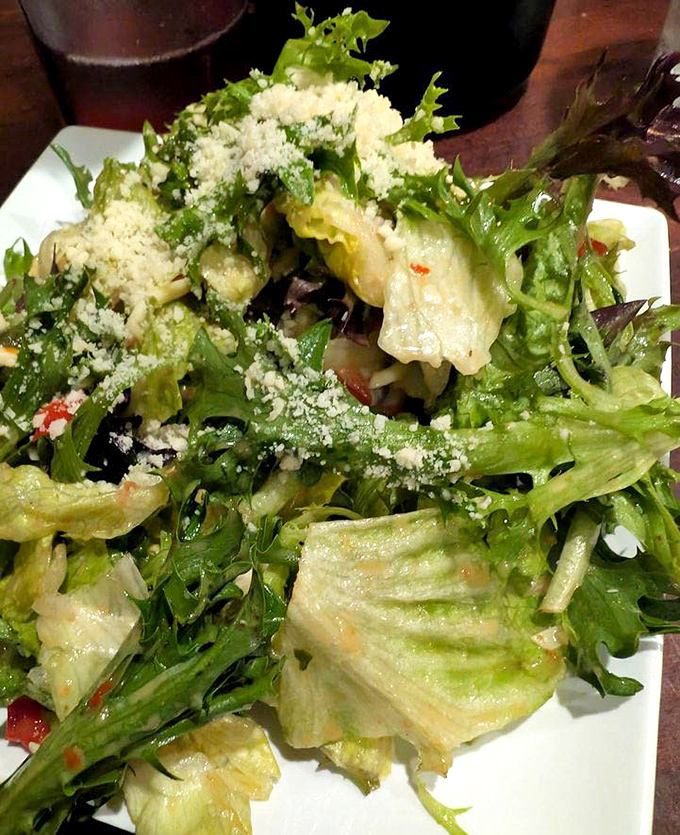 Even the salad gets the star treatment at Mama's, with fresh greens, vibrant vegetables, and a shower of Parmesan that elevates rabbit food to royalty status.