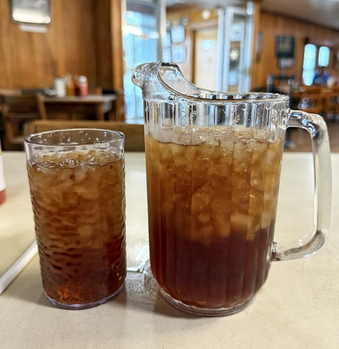 Sweet tea served in portions that acknowledge the seriousness of Southern thirst. That pitcher isn't just a serving vessel&mdash;it's a commitment to proper hydration.