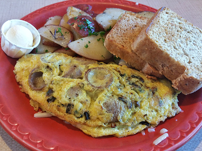 An omelet that would make an Italian grandmother nod in approval, paired with toast substantial enough to support your breakfast dreams.