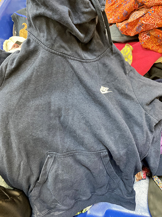 Hidden among the textile layers: a perfectly good Nike hoodie waiting for its second chance. One person's donation becomes another's favorite weekend loungewear.