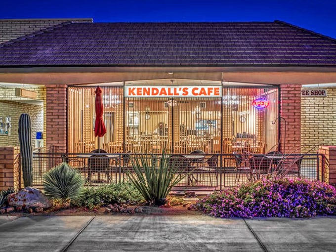 Kendall's Caf&eacute; glows with welcoming warmth against the desert night, promising hearty breakfasts that fuel days of exploration.