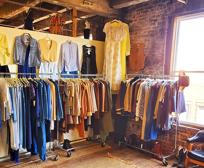 Fashion through the decades hangs against exposed brick walls. That yellow dress might have danced at Studio 54 or attended a garden party in the Midwest.