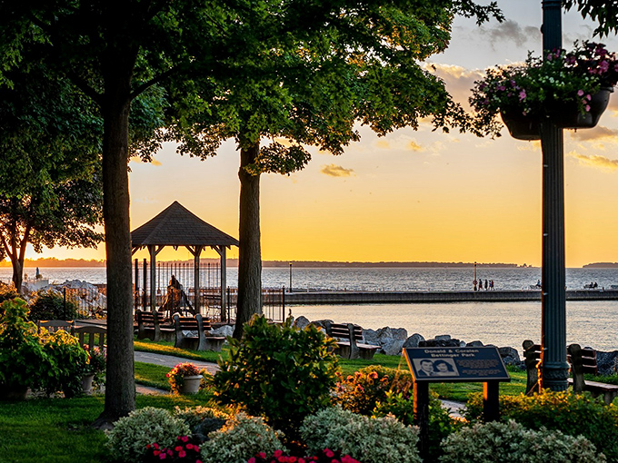Sunset paints Lake Erie gold while gazebo silhouettes frame the perfect end to a perfect day. No filter needed.