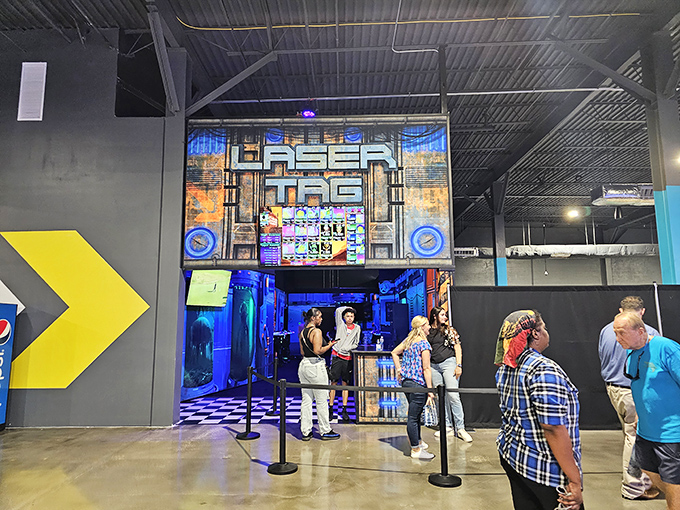 The Laser Tag entrance beckons thrill-seekers with its dramatic lighting and promise of strategic warfare where office politics are temporarily replaced by laser diplomacy.