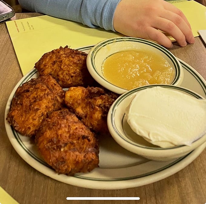 Golden-brown latkes with their crispy edges giving way to tender centers—paired with applesauce and sour cream, they're potato pancake perfection.