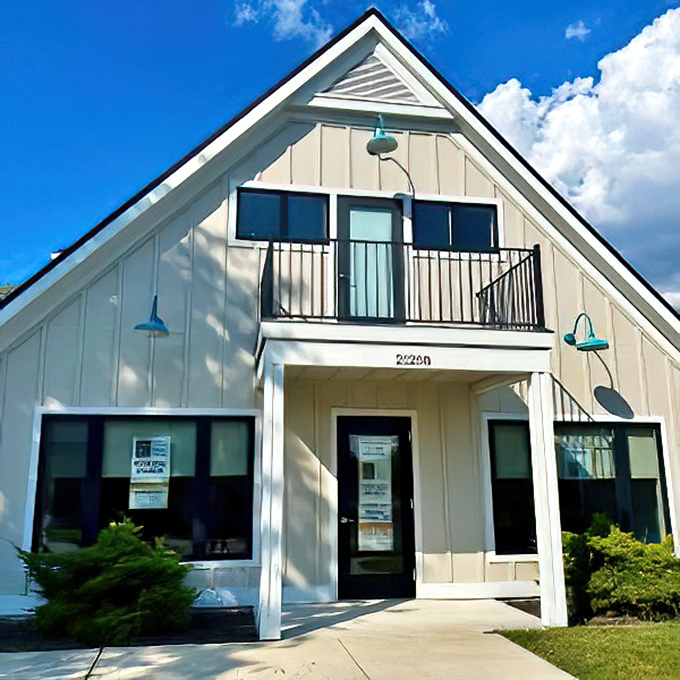 Modern coastal charm meets small-town hospitality at this pristine white building, where the Eastern Shore welcomes visitors with architectural simplicity and blue skies above.