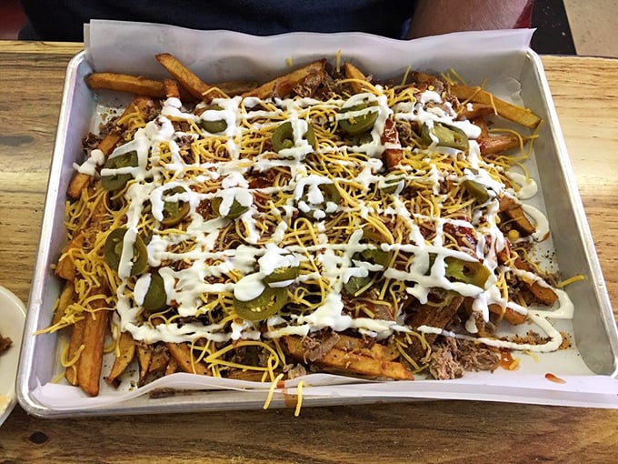Loaded fries that laugh in the face of moderation. Cheese, jalape&ntilde;os, pulled pork, and sauce create a beautiful mess worth every napkin.