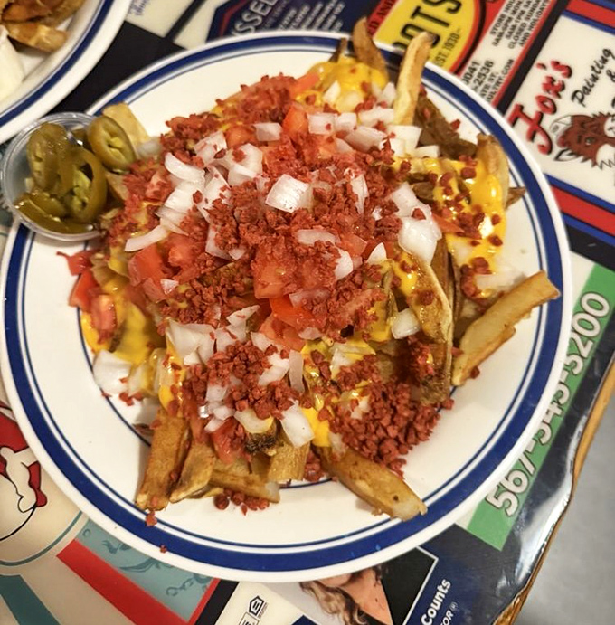 Loaded fries that don't mess around! Cheese, bacon bits, tomatoes, and onions transform humble potatoes into a mountain of indulgence worth conquering.