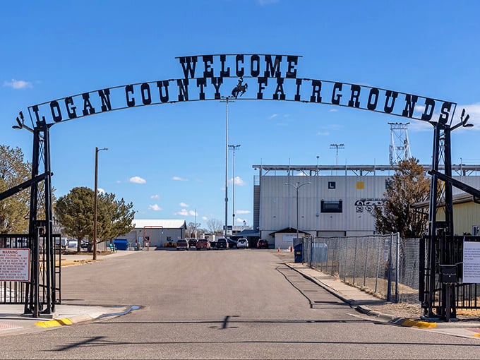 The Logan County Fairgrounds entrance arch stands ready year-round, like a permanent invitation to community gatherings where everyone knows your name.