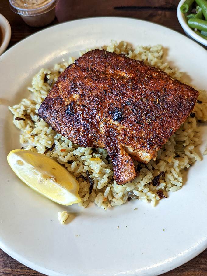 Blackened fish over rice proves Ron's Roost isn't just a one-trick chicken pony—they've got range that would impress even the pickiest seafood lover.