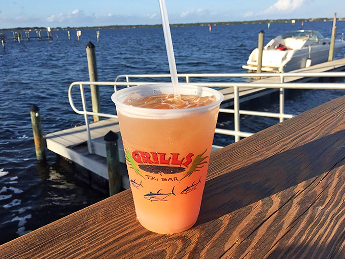 A sunset-colored cocktail with the Grills logo&mdash;because drinking from a regular glass when you're waterside would just be wrong.