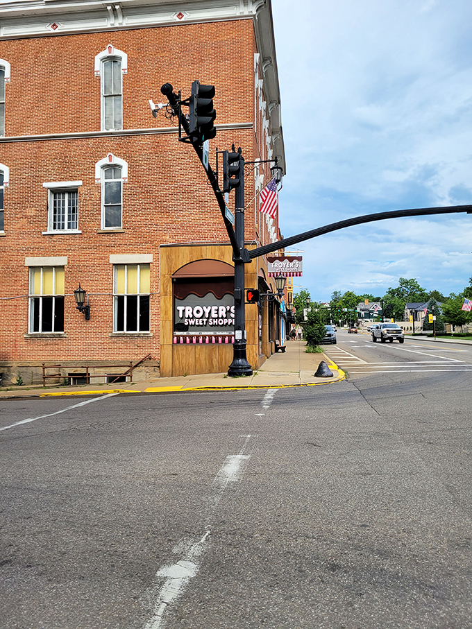 Troyer's Sweet Shoppe sits on the corner like a sugary siren, luring passersby with promises of handcrafted confections worth every calorie.