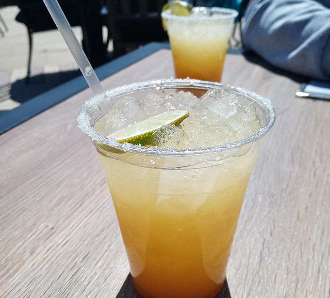 A salt-rimmed glass of liquid sunshine, garnished with lime. This margarita isn't just a drink; it's the official sponsor of vacation decisions.