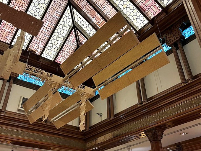 Defying gravity and logic. This intricate matchstick creation hanging from the ornate ceiling proves that sometimes the most impressive art comes from the most humble materials.