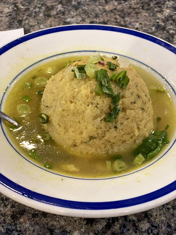 Matzo ball soup that would make any grandmother nod in approval – comfort floating in golden broth.