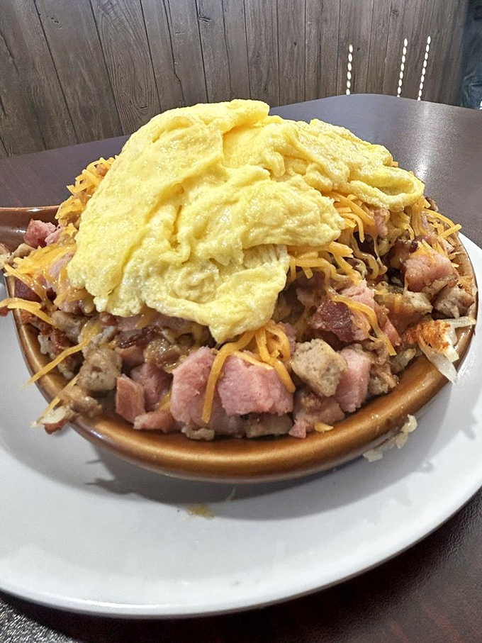 The meat lovers skillet towers like a delicious mountain of bacon, ham, and breakfast dreams come true. 