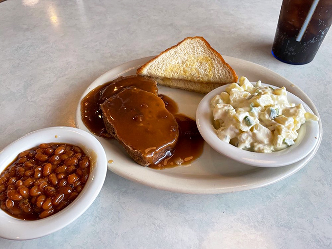 Meatloaf, potato salad, and baked beans &ndash; the holy trinity of American comfort food that tastes like your grandmother's kitchen, if your grandmother was a culinary genius.