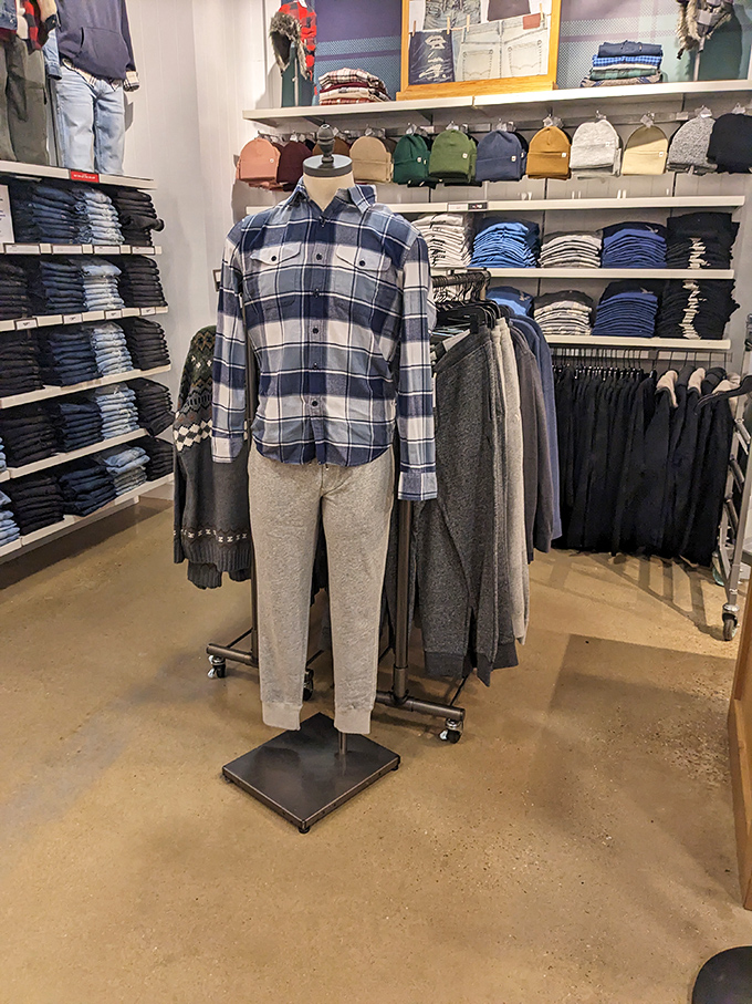 Mannequins sporting the classic blue-and-white flannel uniform of relaxed weekends, standing at attention among neatly folded stacks that promise comfort without breaking the bank.