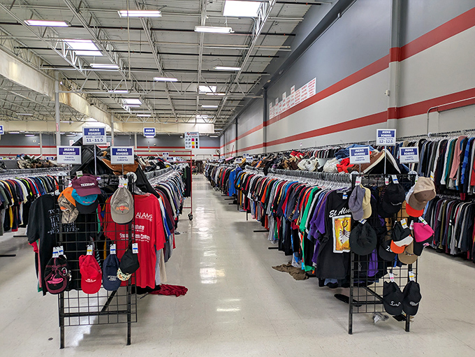 Men's clothing organized with military precision. The serious thrifter moves through these racks with the focus of a big game hunter stalking the perfect blazer.