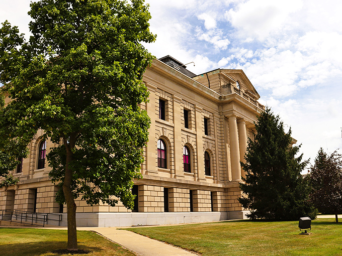 The Miami County Courthouse commands respect with its classical columns and golden hue, like a wedding cake designed by a history professor.