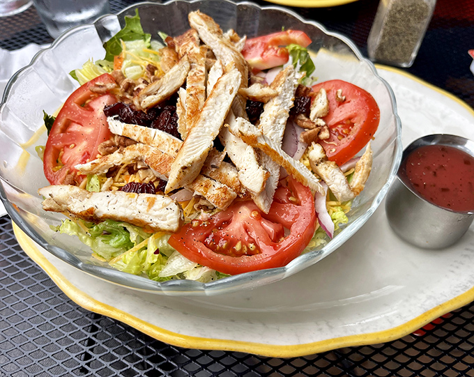A salad that doesn't apologize for being healthy, with grilled chicken standing tall among fresh greens and juicy tomatoes.