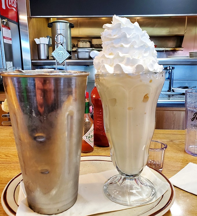 That milkshake isn't just thick &ndash; it's contemplating a career in architecture with that towering whipped cream spire.