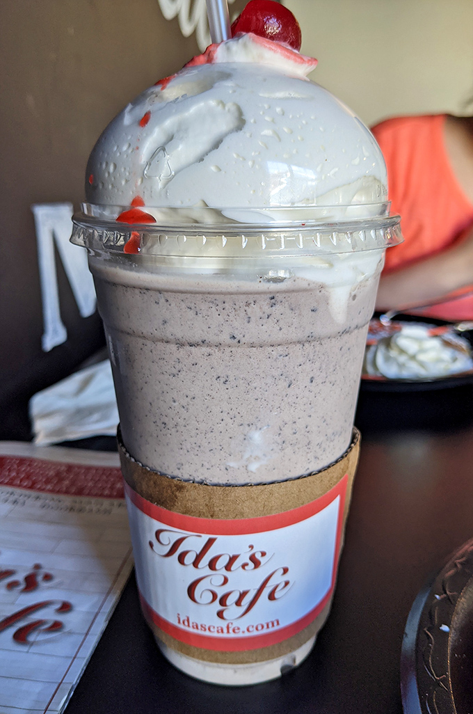 A milkshake so thick it defies gravity, topped with enough whipped cream to make a dairy farmer blush with pride.