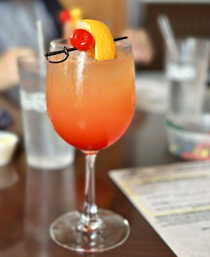 This sunset-hued cocktail isn't just a drink&mdash;it's liquid Florida sunshine in a glass. That tiny sword-skewered cherry is claiming victory over mundane mornings.