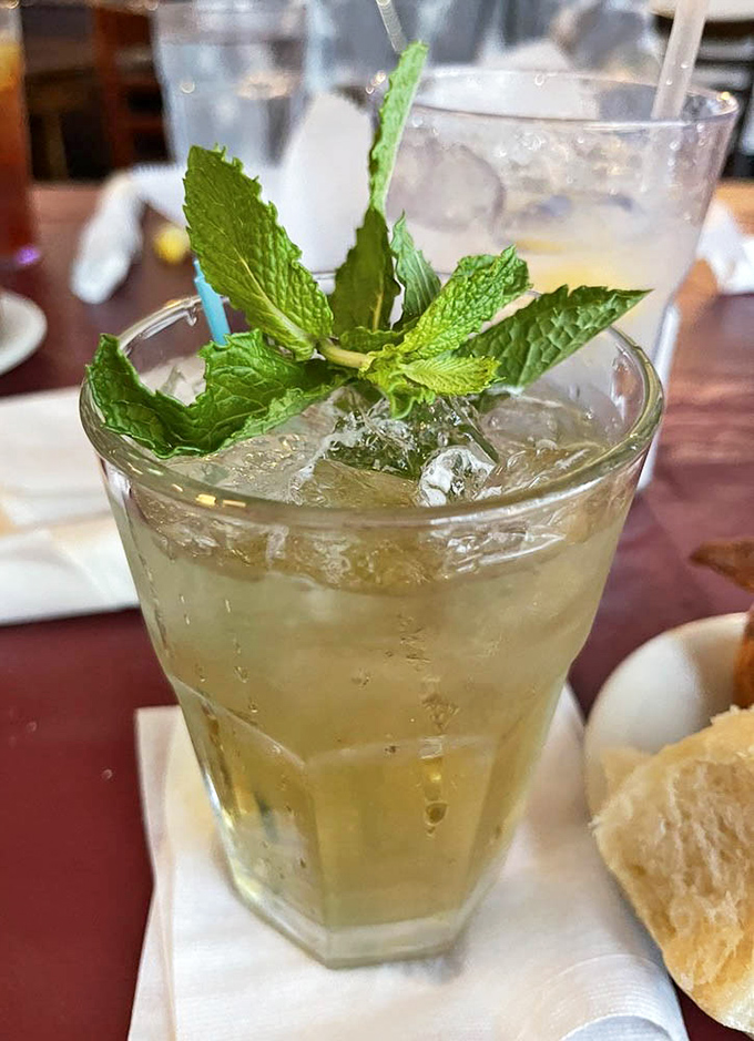 A mint julep garnished with fresh mint &ndash; because sometimes sweet tea needs to kick things up a notch in the most genteel way possible.