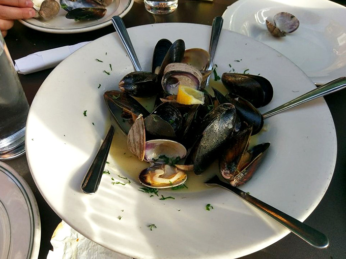 Mussels and clams swimming in aromatic broth that captures the essence of seaside dining perfection.