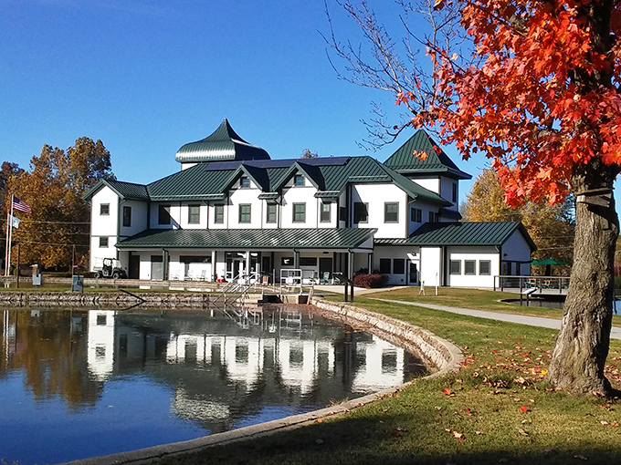 The Neosho National Fish Hatchery Visitor Center reflects in still waters, its distinctive architecture housing stories of conservation efforts dating back to 1888.